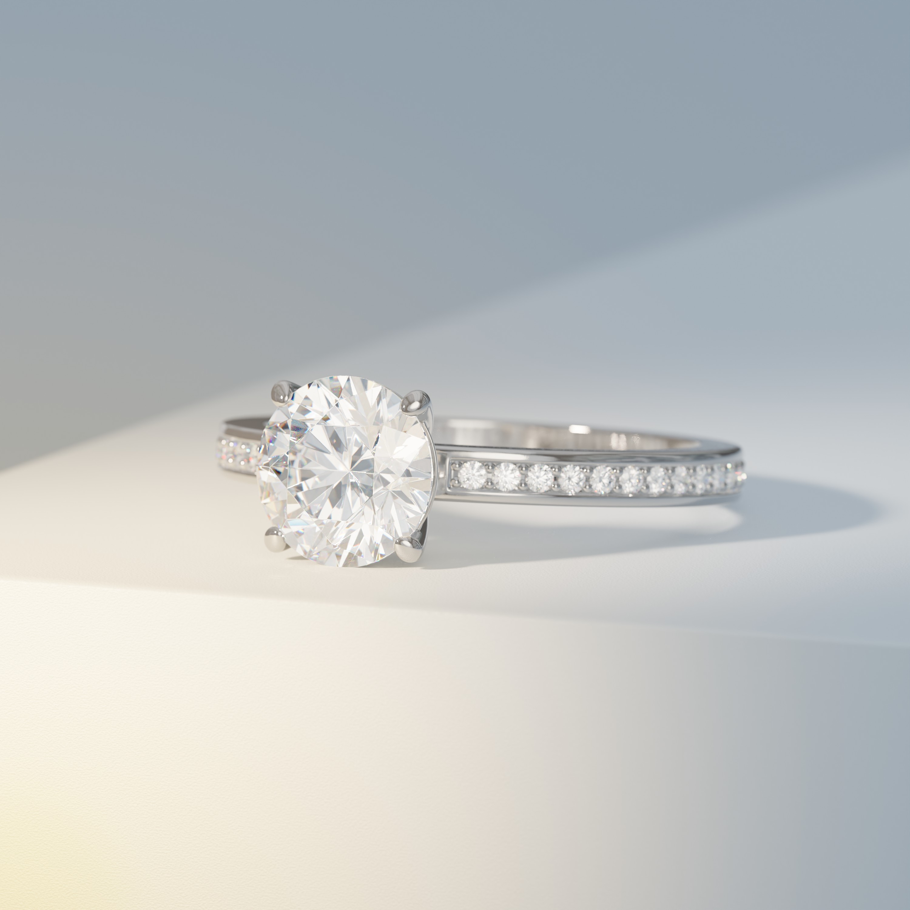 Round Claw Set Solitaire with Pavé Band Engagement Ring | Four Words